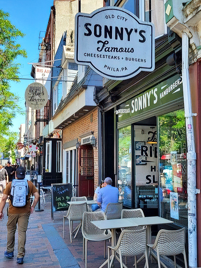 The sidewalk seating scene &ndash; where locals and tourists alike perform the sacred Philly ritual of people-watching while devouring cheesesteak perfection.