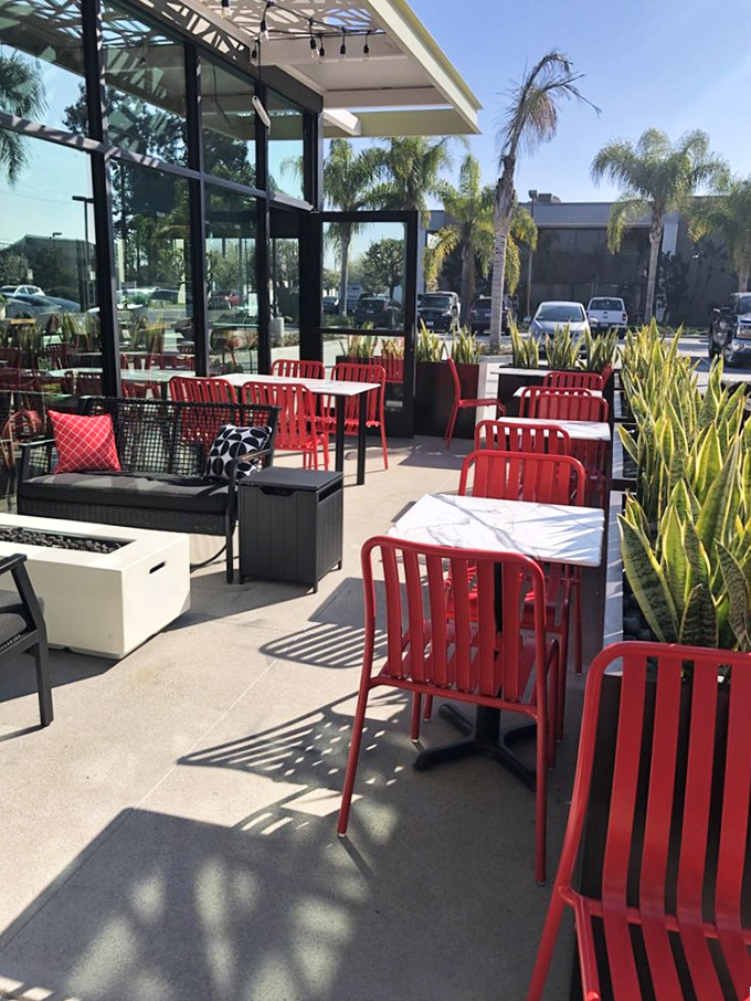 The outdoor patio with its bright red chairs invites you to enjoy your slice under California sunshine&mdash;pizza weather is always perfect weather.