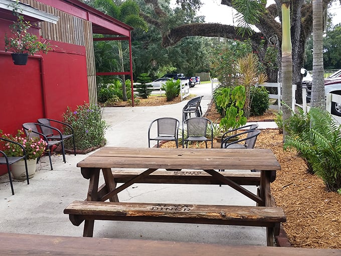 Florida's outdoor dining done right &ndash; picnic tables and palm trees creating a perfect spot for between-meal conversations or pre-meal anticipation.