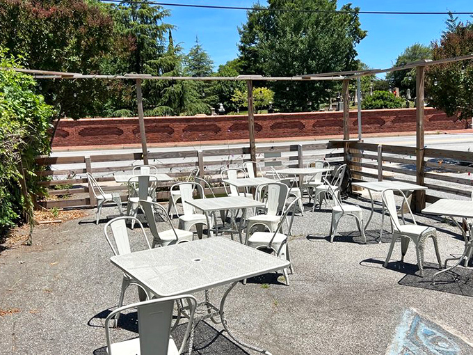 The outdoor seating area&mdash;metal chairs waiting for weekend warriors. Where Atlanta's morning air adds an extra ingredient to every bite. 