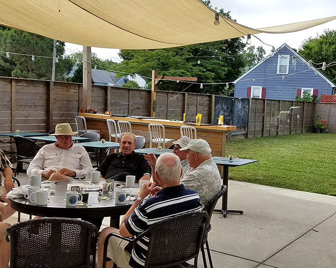 Morning coffee club in session: The Backyard's outdoor seating area has become command central for local wisdom and friendly debates.