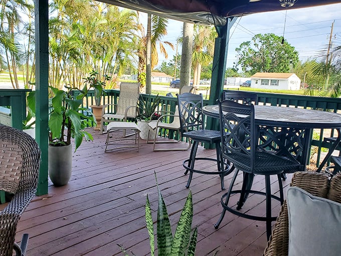 Lush palms frame this peaceful porch setting, offering a moment of tranquility before you dive back into the gloriously messy business of devouring seafood.
