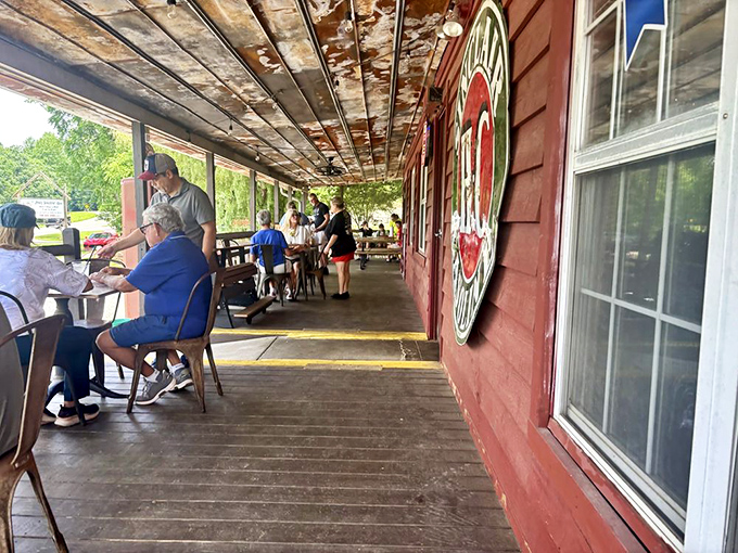 Porch dining where the mountain air mingles with smoke. Some conversations just taste better with barbecue as the backdrop.