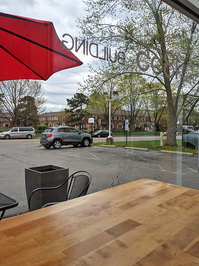 The view from inside looking out—where "1839 PUBLIC DINING" reversed on glass frames the neighborhood beyond. Urban tranquility at its finest.
