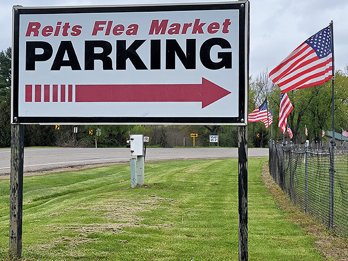 The parking sign stands like a beacon of hope, guiding treasure hunters to their destination with patriotic flair.