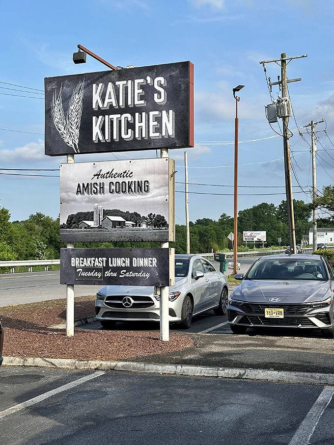 The roadside sign announces "Authentic Amish Cooking" like a delicious promise. Even luxury cars can't resist the gravitational pull of homestyle cooking.