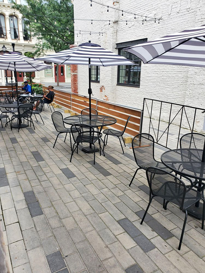 The patio where summer evenings stretch into night, string lights twinkling above conversations that nobody wants to end.