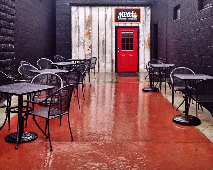 The patio&mdash;where the red door stands like a portal to meat paradise. Rain or shine, this space promises smoky delights ahead.