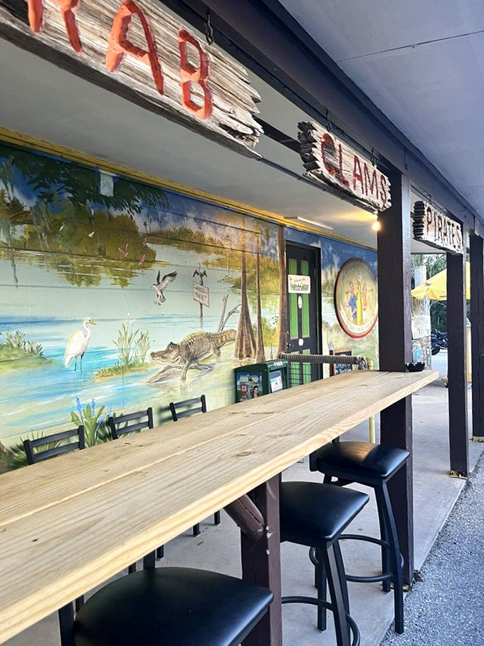 Outdoor seating with a side of Florida wildlife murals&mdash;because dining without alligator art just doesn't feel authentic in these parts.
