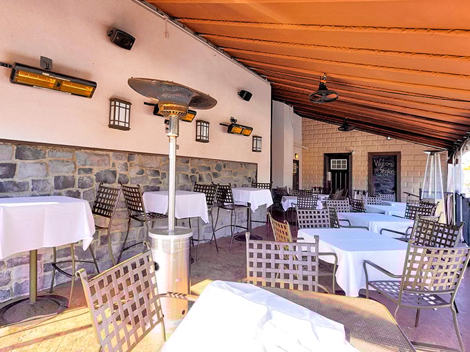 Covered patio dining combines the best of indoors and outdoors. Stone walls and white tablecloths create an al fresco experience worth savoring.