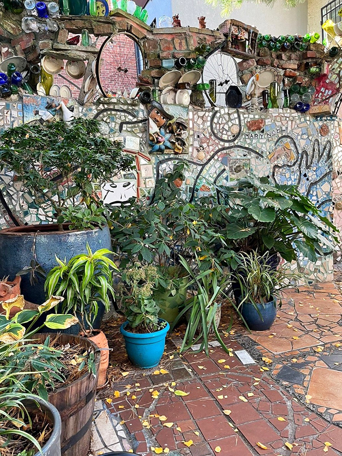 Nature and art achieve perfect harmony as plants add living texture to the permanent mosaic installation. Even the garden pots couldn't escape decoration!