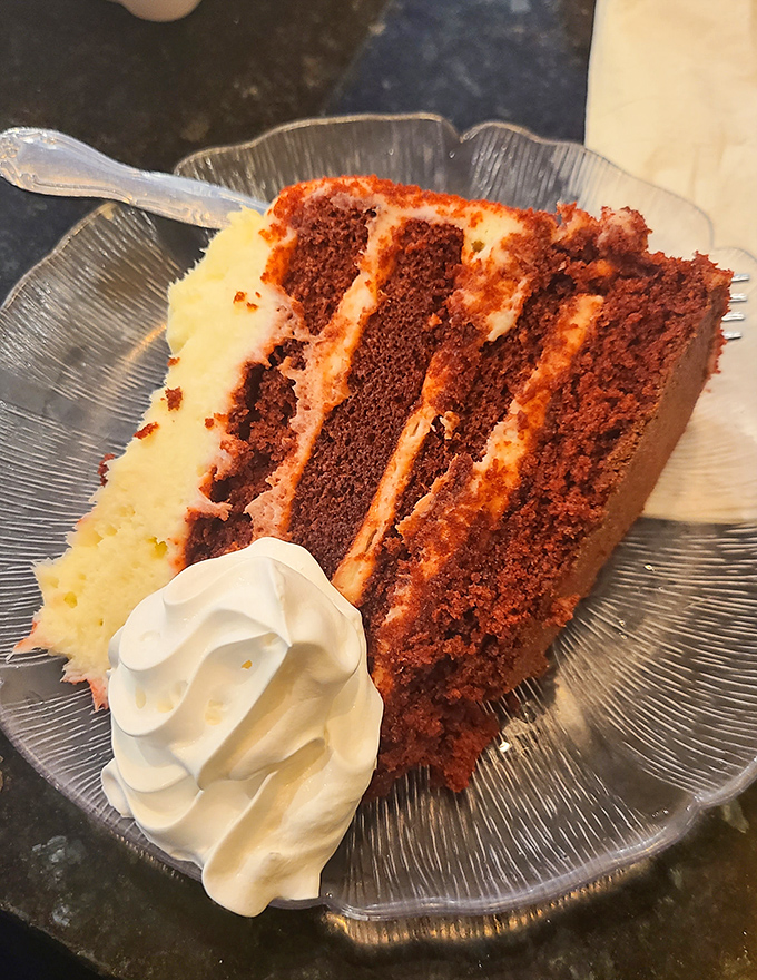 A slice of red velvet cake large enough to share but good enough that you'll conveniently "forget" to offer anyone a bite.