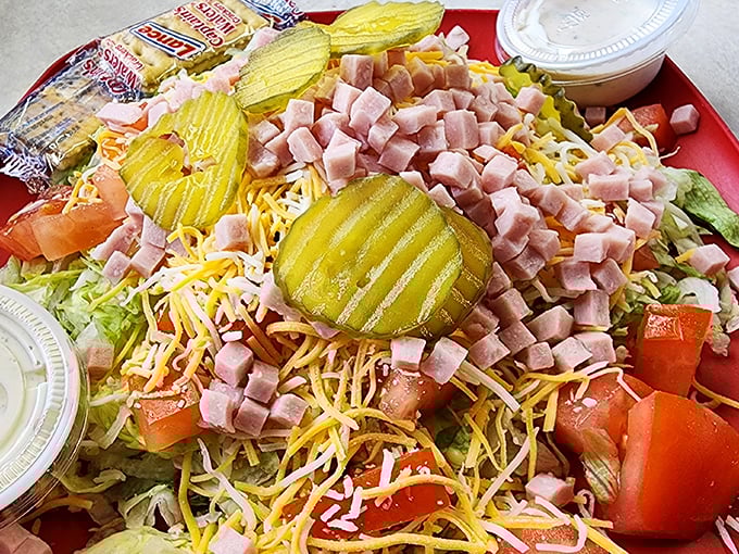 This isn't just a chef salad &ndash; it's a celebration. Those pickle chips stand like flavor sentinels guarding a kingdom of ham, cheese, and fresh veggies.