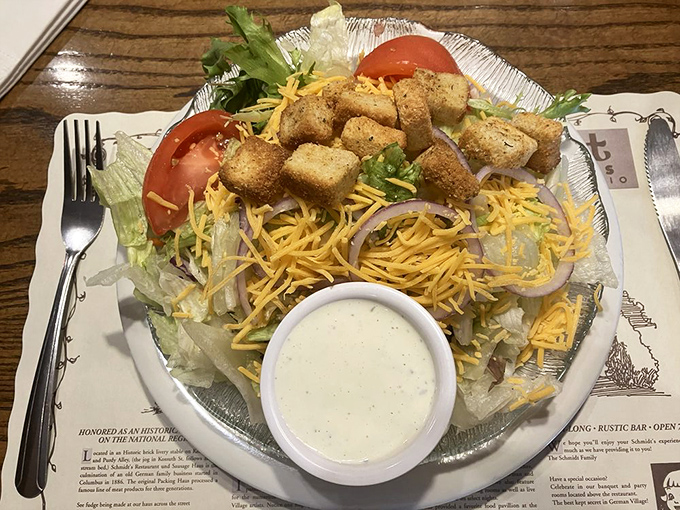A salad that doesn't apologize for being a salad&mdash;loaded with cheese, croutons, and enough toppings to make you temporarily forget about the schnitzel you ordered.