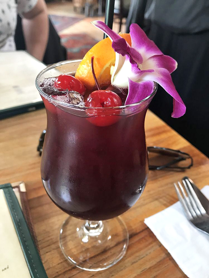 This sangria isn't just a drink, it's a vacation in a glass. The orchid garnish is showing off, but when something looks this good, it's earned the right.