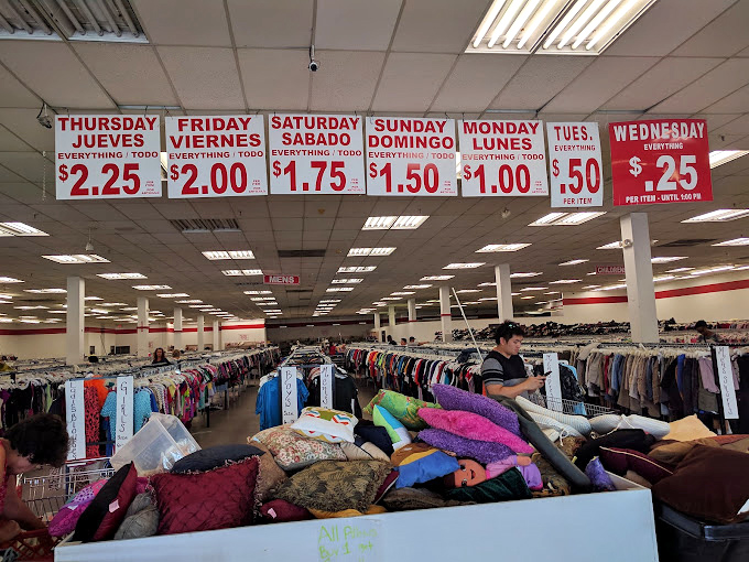 Overhead signs announce the day's deals like scorecards at a championship game of bargain hunting.