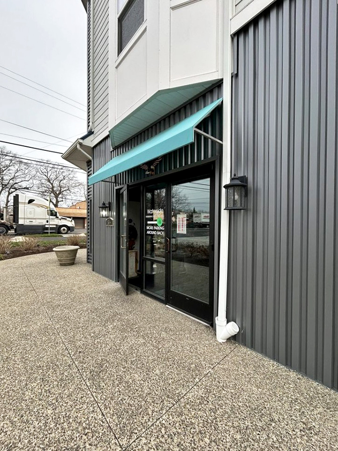 The side entrance promises no pretension, just good food. Those teal awnings are like beacons guiding hungry travelers to breakfast salvation.