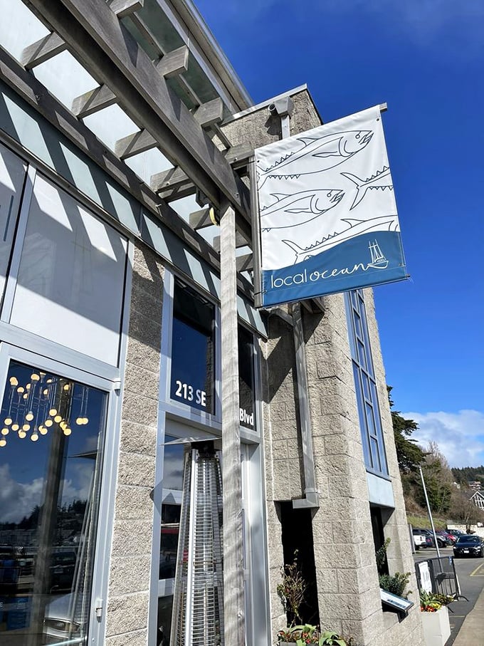 The flag flies proudly, announcing "seafood paradise ahead." This simple sign is like a lighthouse beacon for hungry travelers navigating the Oregon coast.