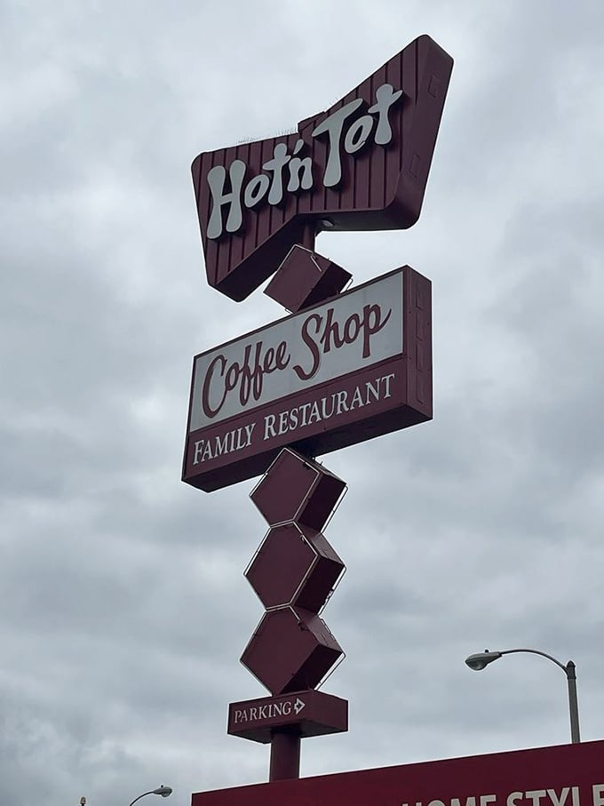 Even on cloudy days, this vintage sign shines like a beacon for hungry travelers. Mid-century design that's aged better than most Hollywood stars.