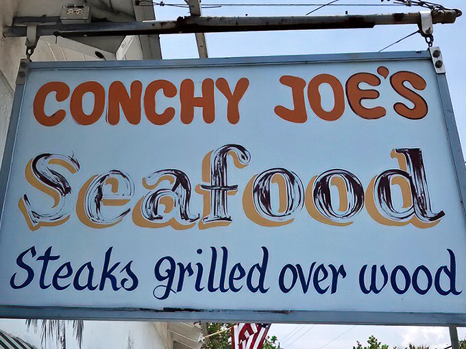 The sign doesn't just announce a restaurant; it declares a philosophy where seafood and wood-grilled steaks are treated with proper respect.