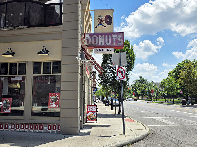 The vintage sign stands as a landmark on High Street, guiding hungry souls to donut salvation like a sugary lighthouse.