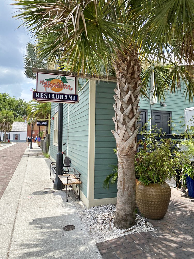 The restaurant's sign sways gently beneath palm fronds&mdash;a perfect marriage of Old Florida charm and contemporary culinary promise.