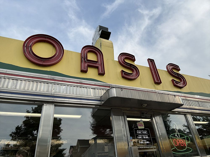 The neon-red OASIS letters have guided hungry travelers for decades, promising refuge from fast food monotony and a taste of authentic diner magic.