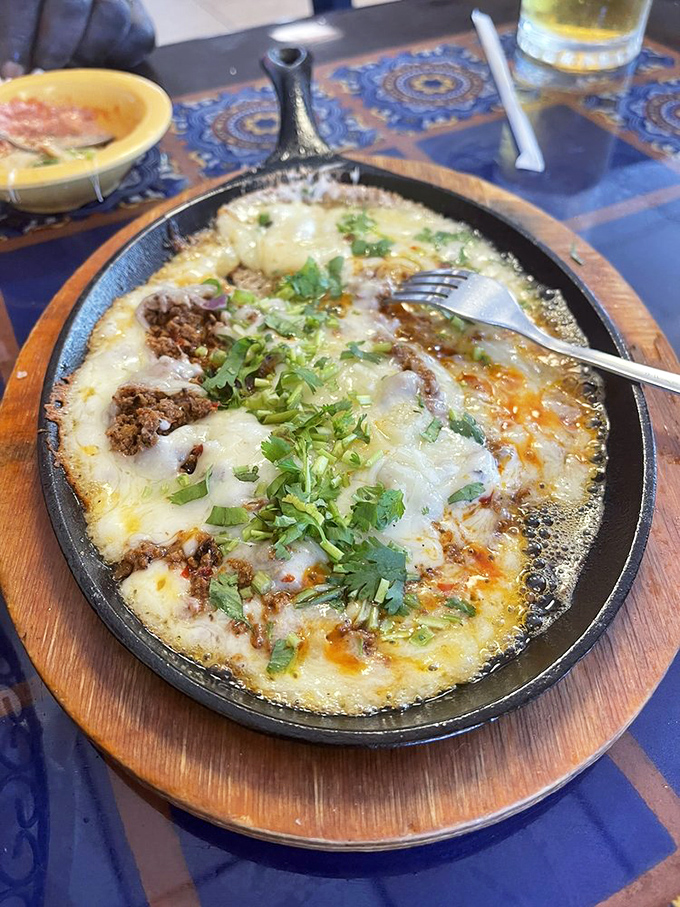Queso fundido bubbling in its cast iron skillet like a cheese volcano on the verge of a delicious eruption. Resistance is futile.