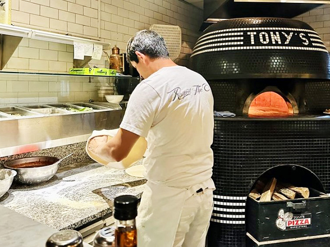 Behind every perfect pizza is a dedicated artisan and a 900-degree oven. This isn't cooking—it's a carefully choreographed dance between dough, fire, and expertise.