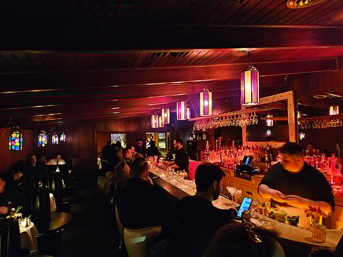 The bar buzzes with energy as patrons gather for pre-dinner libations. Those colorful pendant lights aren't just illumination&mdash;they're mood-setters for the evening ahead.