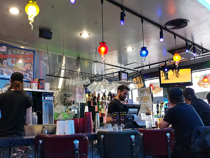 The bustling heart of Galaxy Diner, where staff orchestrate the cosmic dance of orders, conversations, and coffee refills with practiced precision.