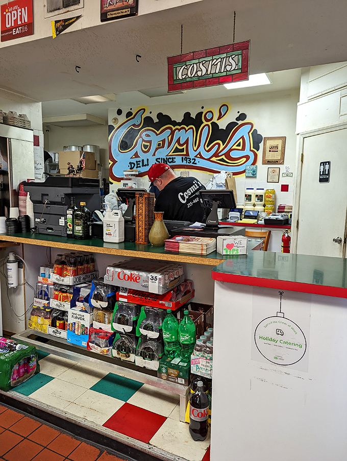 Behind this counter, sandwich magic happens daily. The colorful mural reminds you this isn't just lunch&mdash;it's a South Philly institution.