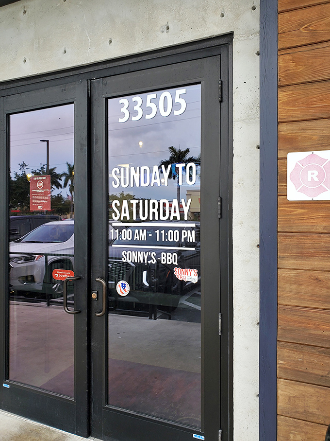 Hours posted like a promise: "We'll be here when you need us." In barbecue terms, that's a commitment to relationship, not just a transaction.