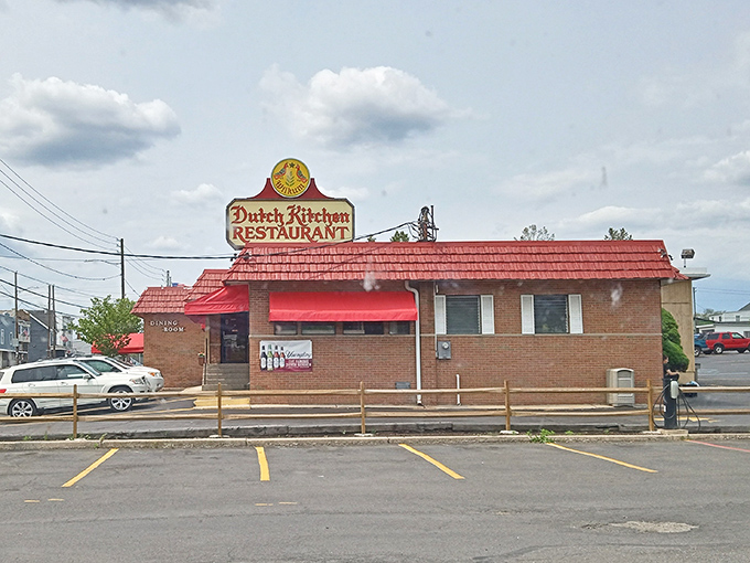 The Dutch Kitchen's exterior promises no-nonsense deliciousness. That red roof has guided hungry travelers like a culinary lighthouse for generations.