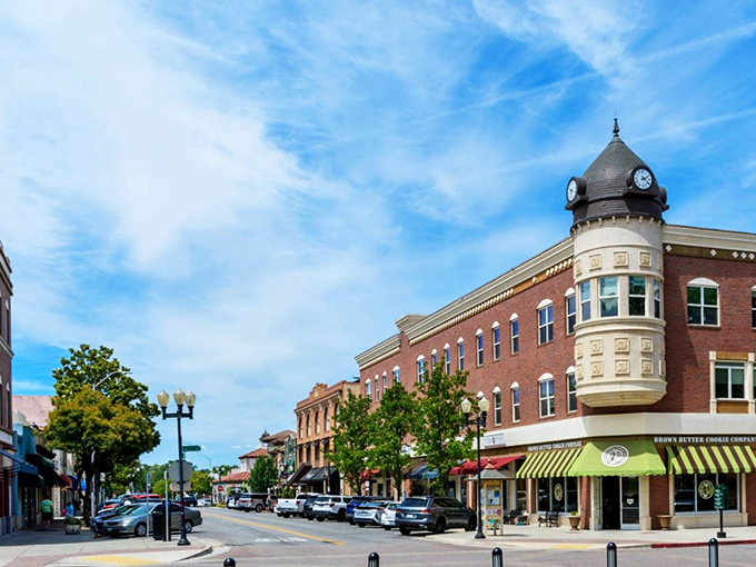 The distinctive downtown skyline welcomes visitors with architectural character. That green awning marks the spot where coffee and local gossip flow freely.