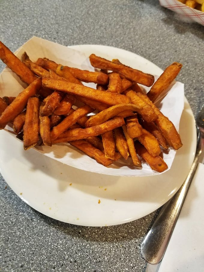 Sweet potato fries that bridge the gap between side dish and dessert—crispy, slightly sweet, and impossible to stop eating until the plate is embarrassingly empty.
