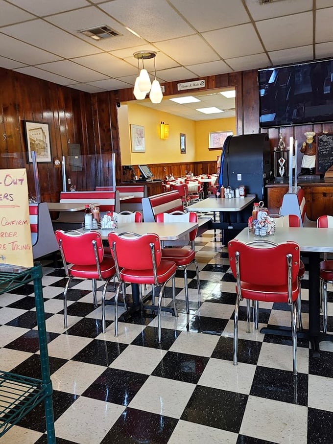 Empty tables that won't stay that way for long. The red chairs wait expectantly for the morning rush and stories they'll overhear.