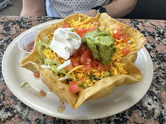 Taco salad served in a freshly fried tortilla bowl&mdash;because in Texas, even salads deserve a crunchy, edible vessel. That's not just lunch, it's an experience.