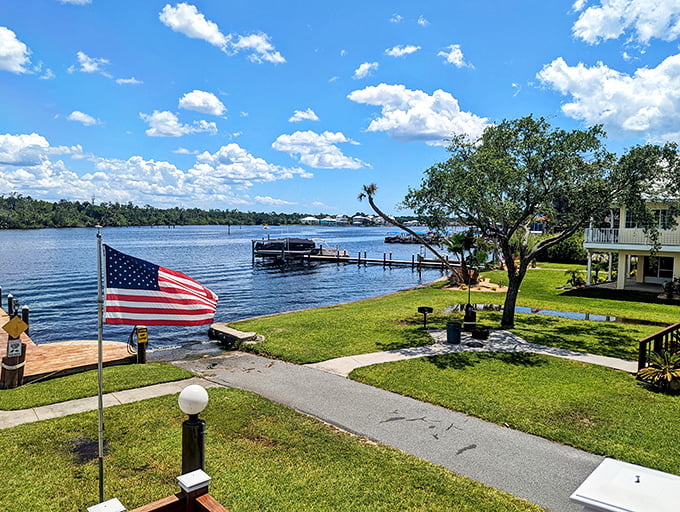 The American flag stands proud against a backdrop of peaceful waterfront homes where residents have traded rush hour for fishing hour.