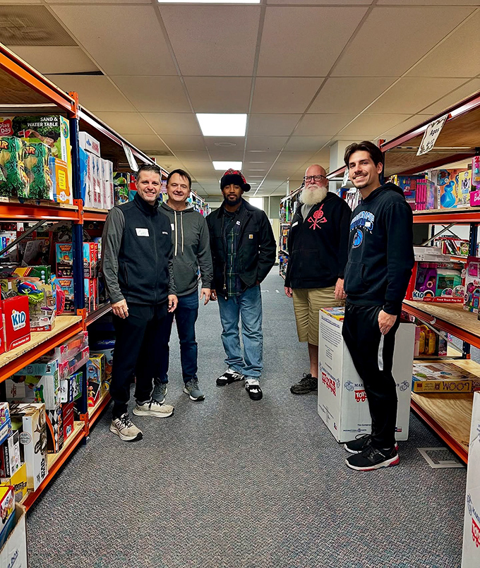 Community in action&mdash;volunteers and visitors sharing the joy of discovery between aisles of potential treasures.