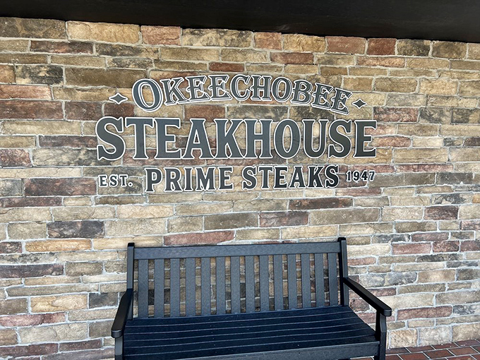 This isn't just a bench&mdash;it's where anticipation builds. Sitting beneath that brick sign, you're moments away from joining the ranks of satisfied carnivores.