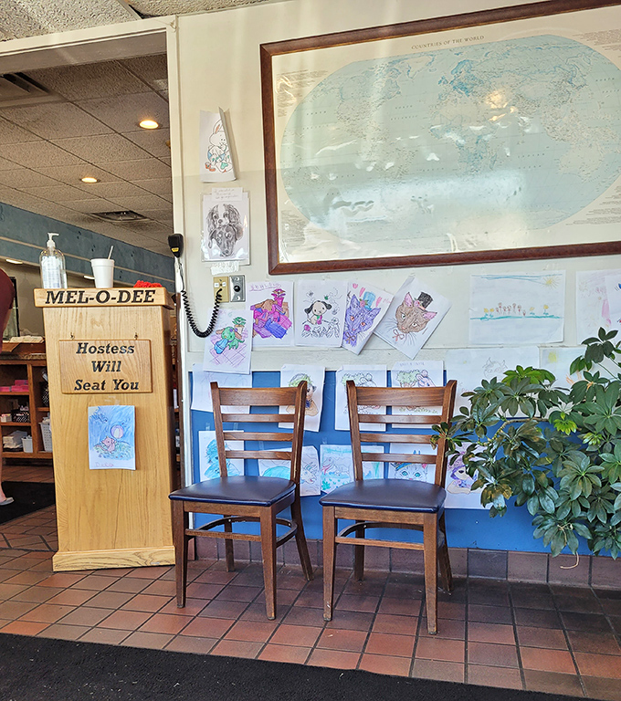 "Hostess Will Seat You" sign and children's artwork&mdash;small touches that transform a restaurant into a community gathering place.