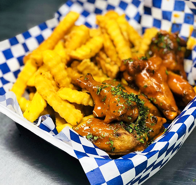 These aren't just wings&mdash;they're flavor delivery vehicles with fries riding shotgun. The sauce glistens with promises it fully intends to keep.