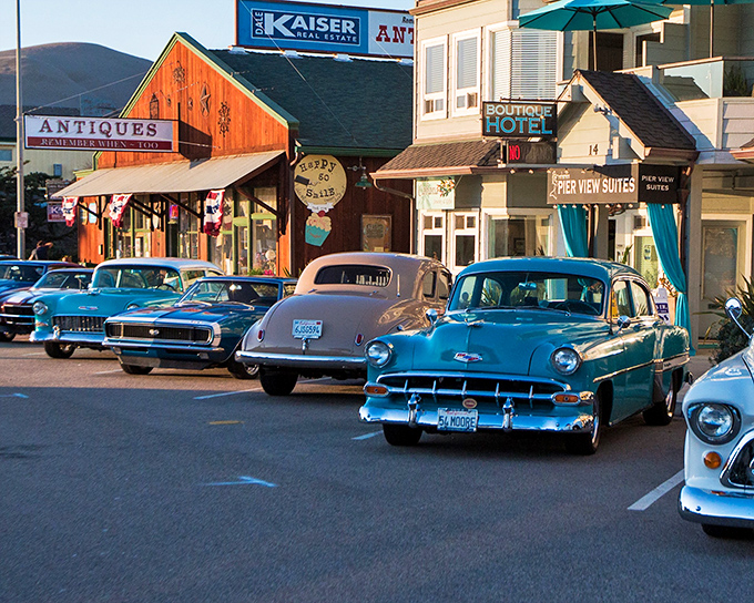 Cayucos maintains old California beach town charm where classic cars cruise past antique shops. 