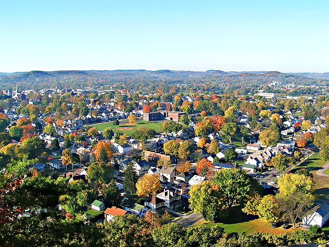 This aerial view reveals how the historic village nestles perfectly into modern Coshocton's rolling autumn landscape.