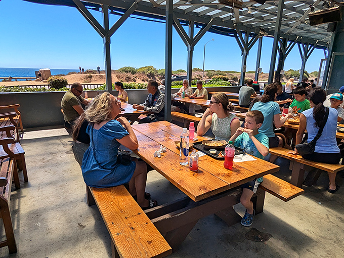 The outdoor dining area &ndash; where strangers become temporary friends, united by ocean views and the universal language of "pass the tartar sauce."