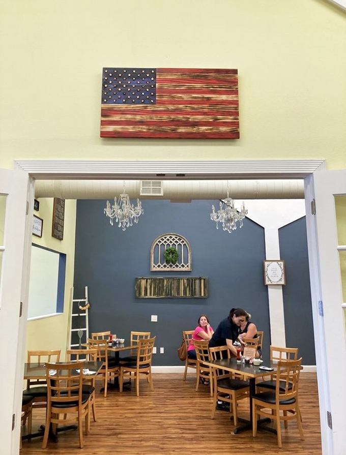 Elegant chandeliers hang unexpectedly in this blue-walled dining area, proving that breakfast can indeed be served with a side of sophistication.