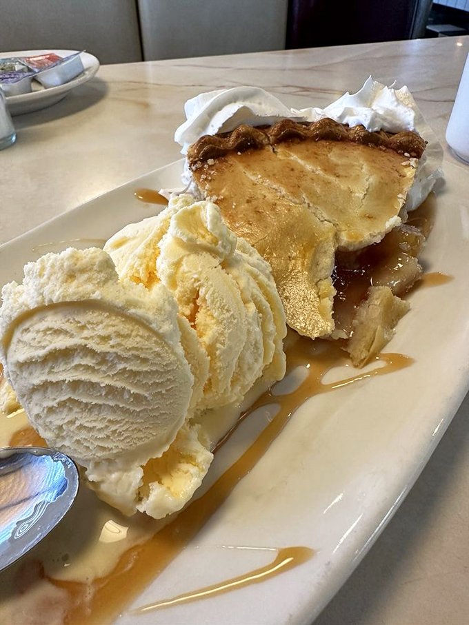 Apple pie &agrave; la mode: the dessert equivalent of a warm hug. That caramel drizzle isn't just decoration&mdash;it's the golden thread connecting you to generations of sweet-toothed Americans.