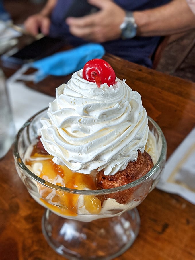 This isn't just dessert &ndash; it's architecture. A fritter foundation supporting caramel, ice cream, and whipped cream, crowned with a cherry that's just there to make other desserts jealous.