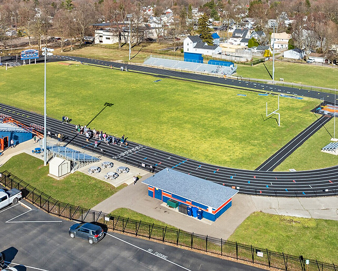 The high school athletic field stands ready for Friday night lights&mdash;where entire communities still gather to cheer on local heroes in cleats.